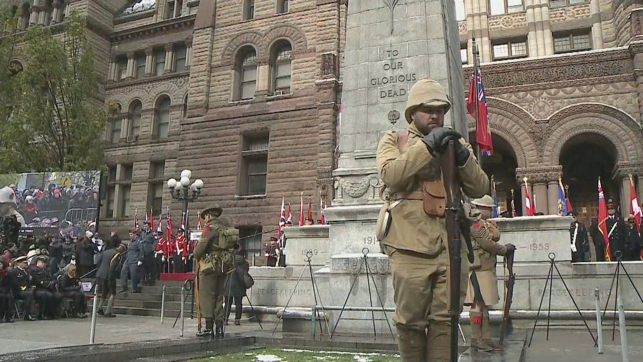 Torontonians gather in the snow to mark Remembrance Day
