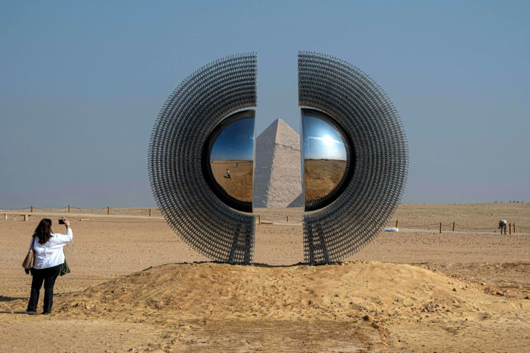 Monumental art displayed in shade of Egypt's pyramids