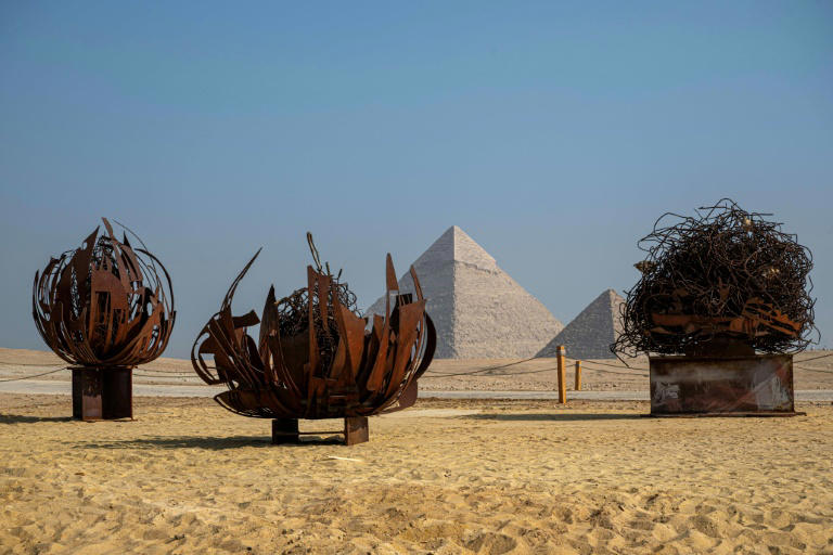 Monumental art displayed in shade of Egypt's pyramids