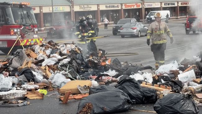 Garbage Truck Driver Dumps Burning Trash at Plaza Parking Lot