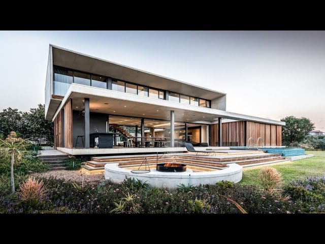 Concrete and wood house brings the outdoors in through the swimming pool