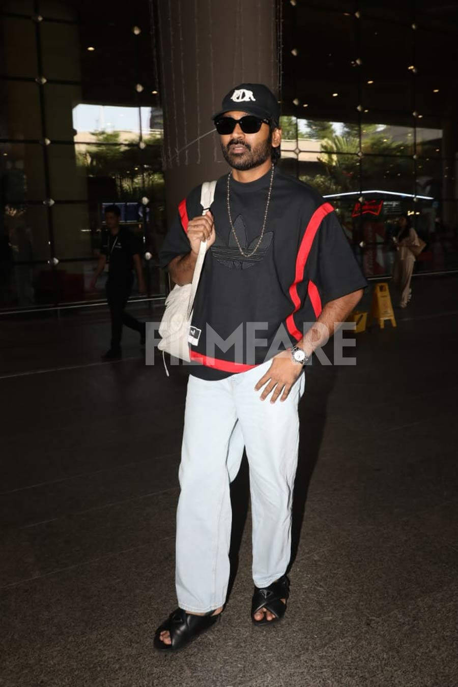 Photos: Dhanush Keeps It Stylish at The Airport