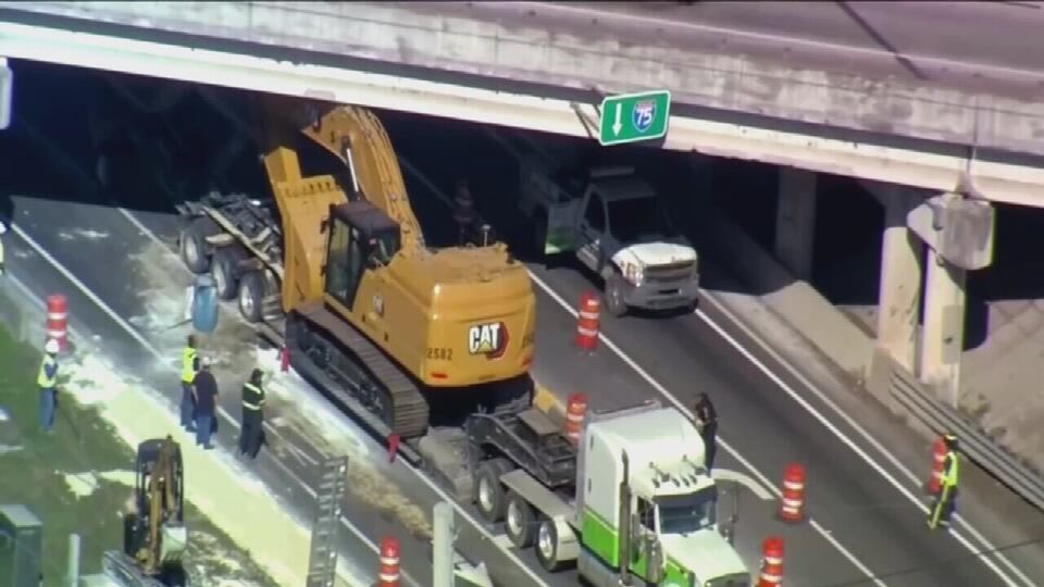 Excavator hits highway bridge, causing major traffic jams