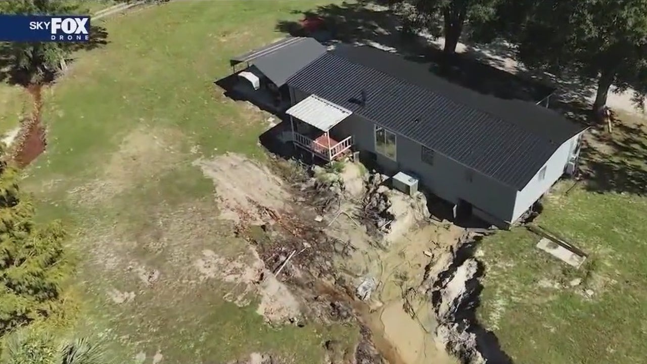 Torrential rain carves massive gully under Mount Dora house, displacing ...