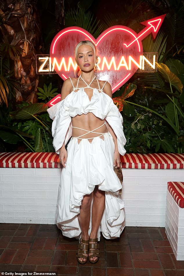 Rita Ora flashes abs in quirky dress as she joins elegant Dakota ...