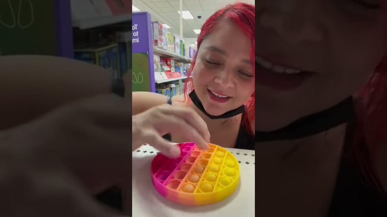 Playing with opened Pop It toys at Target