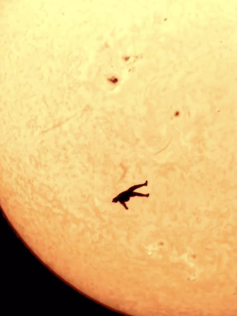 Photographer captures skydiver silhouetted against sun in stunning image