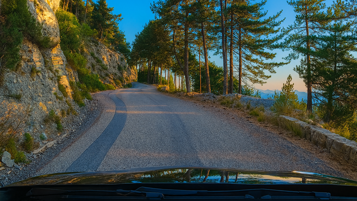 What Awaits Beyond This Alpine Road?