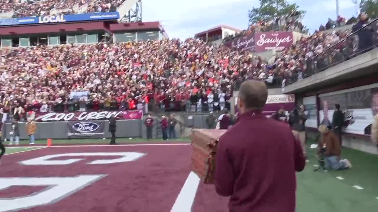 UM President Seth Bodnar delivers pizza during Brawl of the Wild