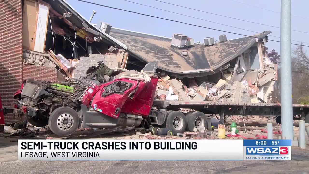 Truck crashes into building; driver rescued