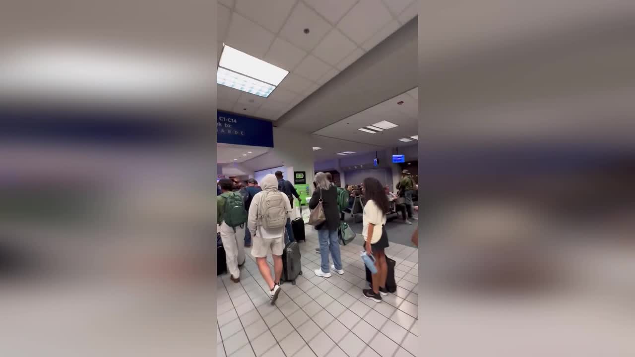 Passengers queue in long lines amid delays at Dallas Fort Worth Airport