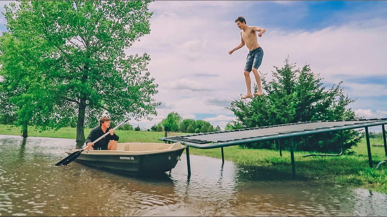 Trampoline tricks into flooded backyard for crazy fun