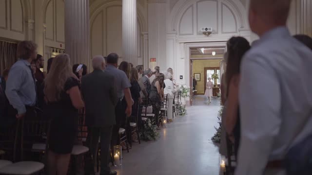 Wedding guests receive a delightful surprise from grandma as flower girl