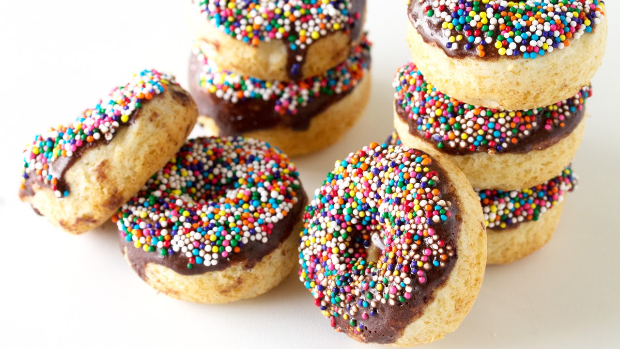 Baked vanilla cake donuts with chocolate glaze and sprinkles