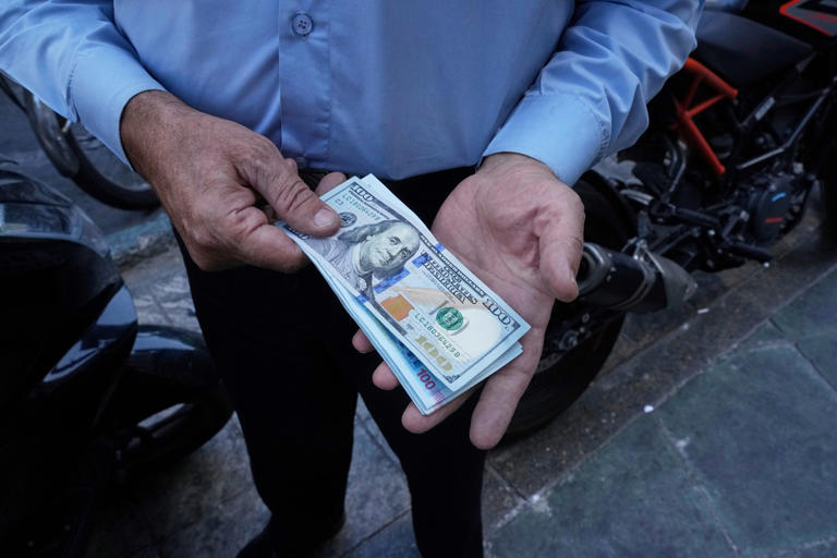 Iran's currency falls to a new low as nuclear sanctions squeeze its ...