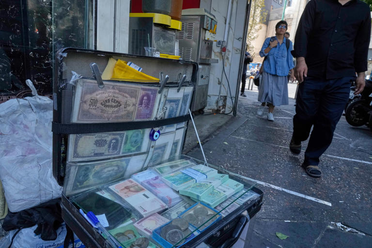 Iran's currency falls to a new low as nuclear sanctions squeeze its ...