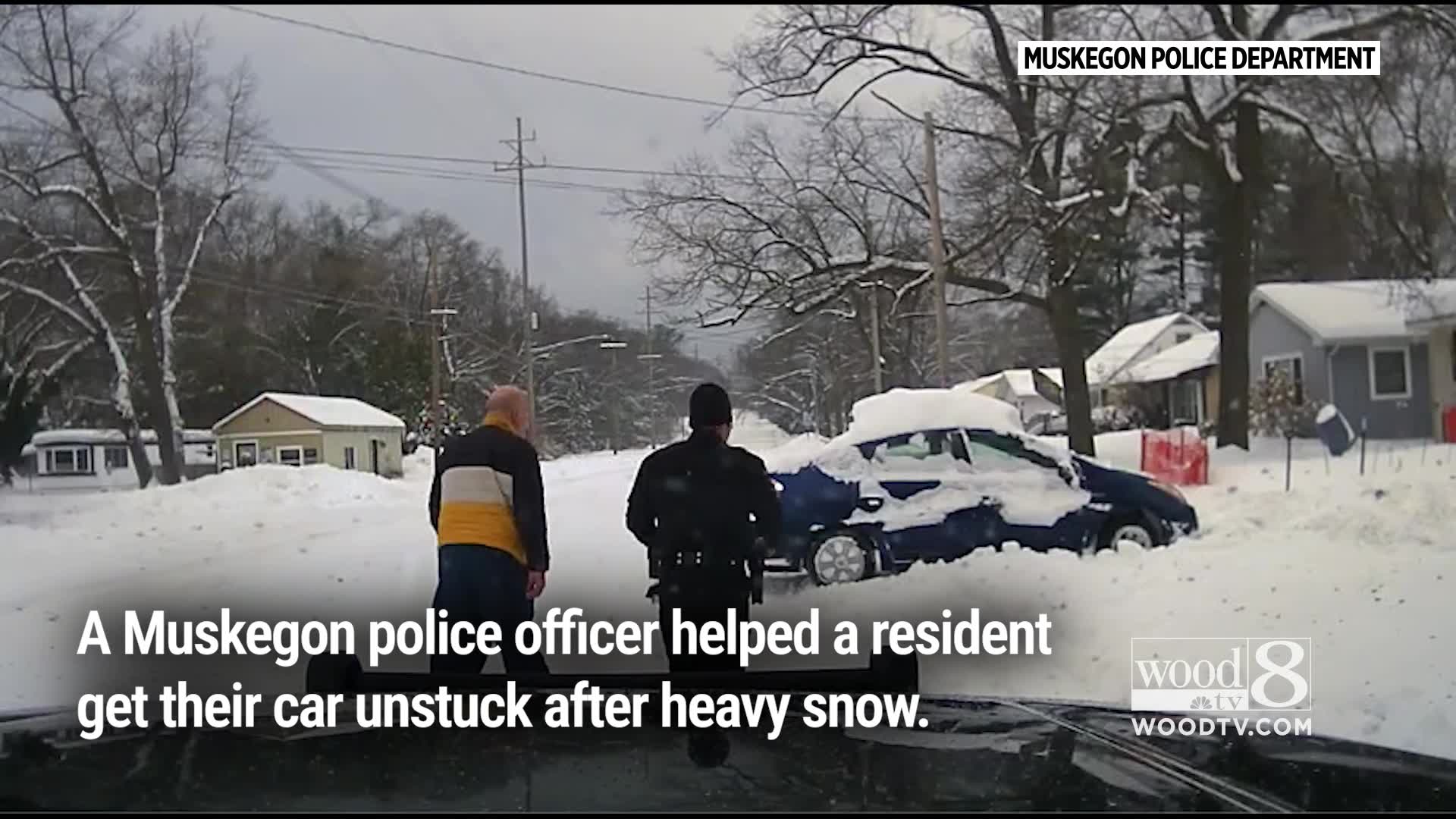 Muskegon police officer helps push car out of heavy snow