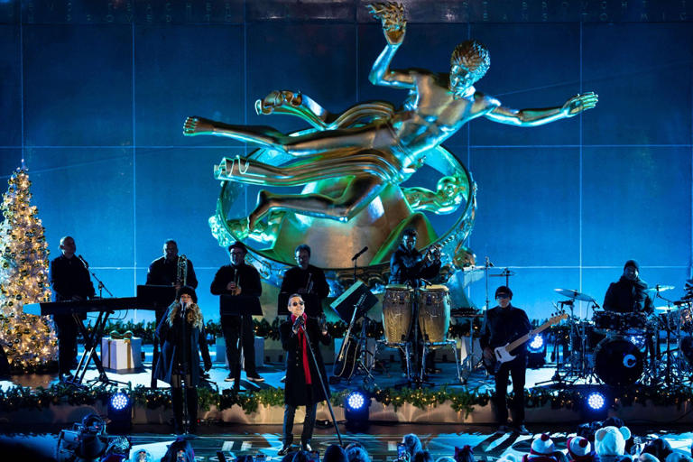 The Rockefeller Center Christmas tree, a holiday icon, is illuminated ...