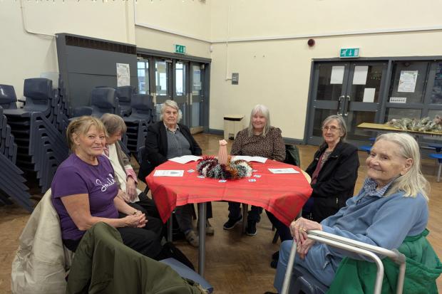 Care home residents enjoy school Christmas coffee morning