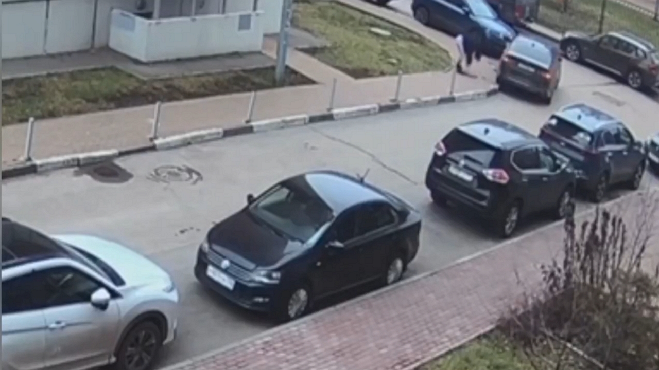 Woman smashes parked car with manhole cover in Olgino, Russia