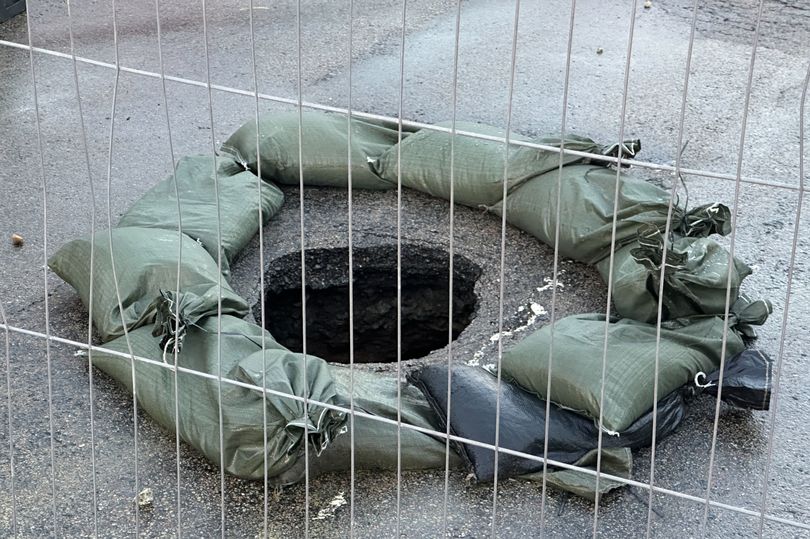 Sinkhole shuts down entire road as photos reveal extent of damage