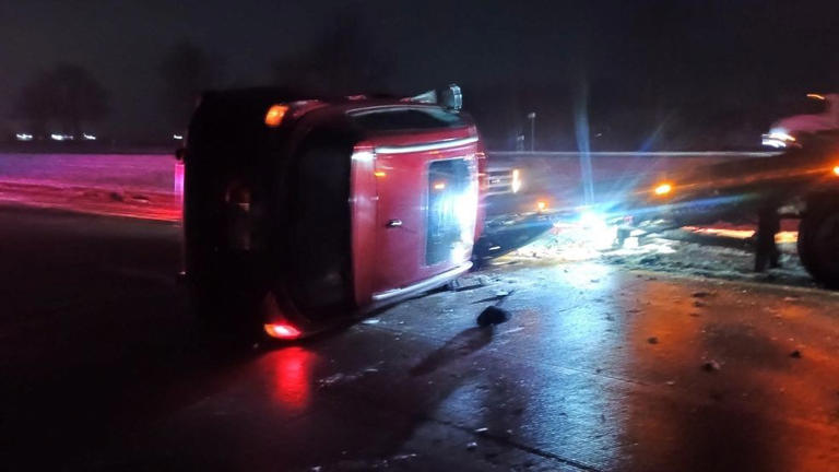 Person injured after driving up bed of tow truck, flipping car in ...