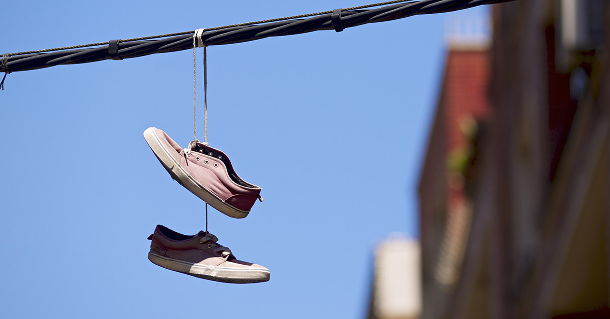 The real reasons you sometimes see shoes dangling from power lines