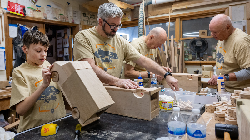 Volunteers build joy in Lawrence, one wooden truck at a time