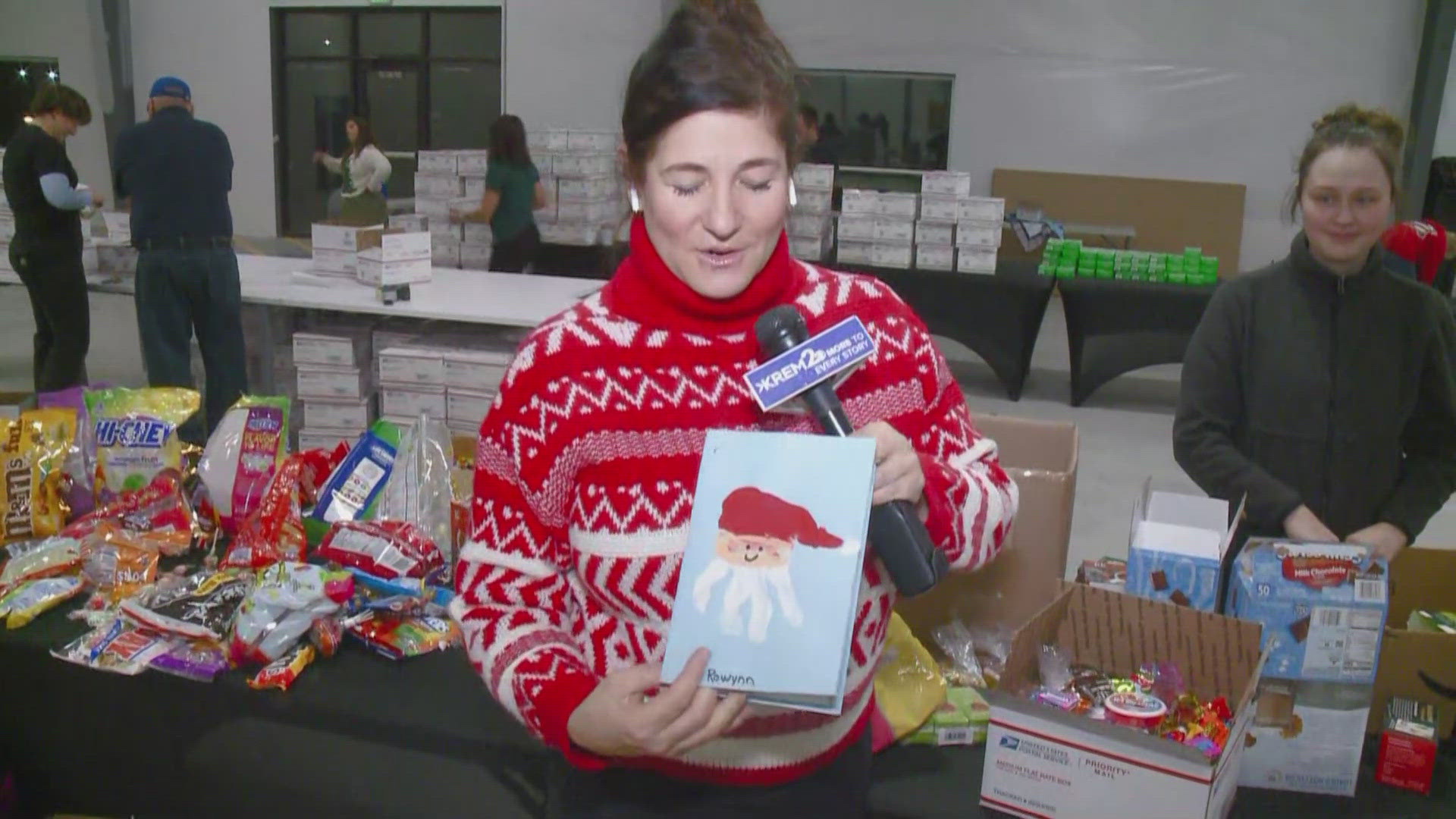 Treats 2 Troops volunteers packing holiday gifts for military members
