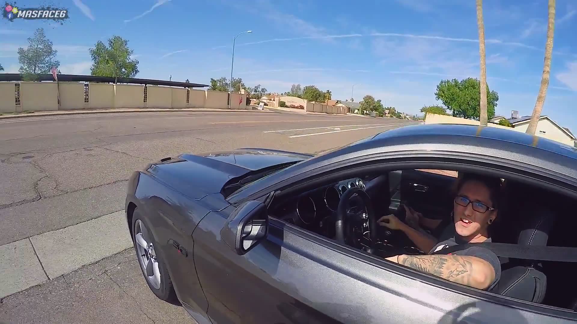 Street racing challenge between sport bike and muscle car at traffic light