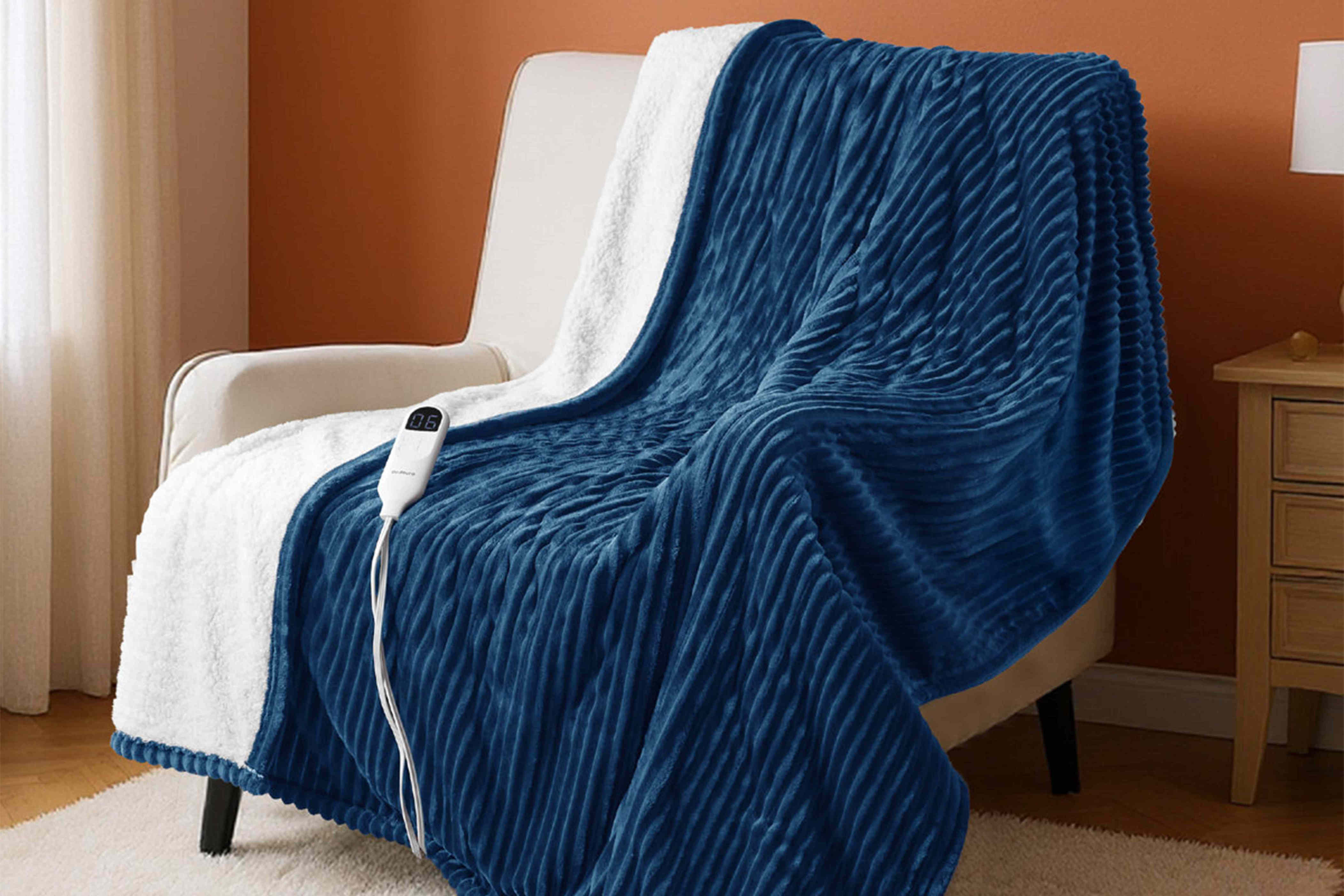 This cozy, heated navy blue throw blanket is a 'lifesaver on a cold day ...