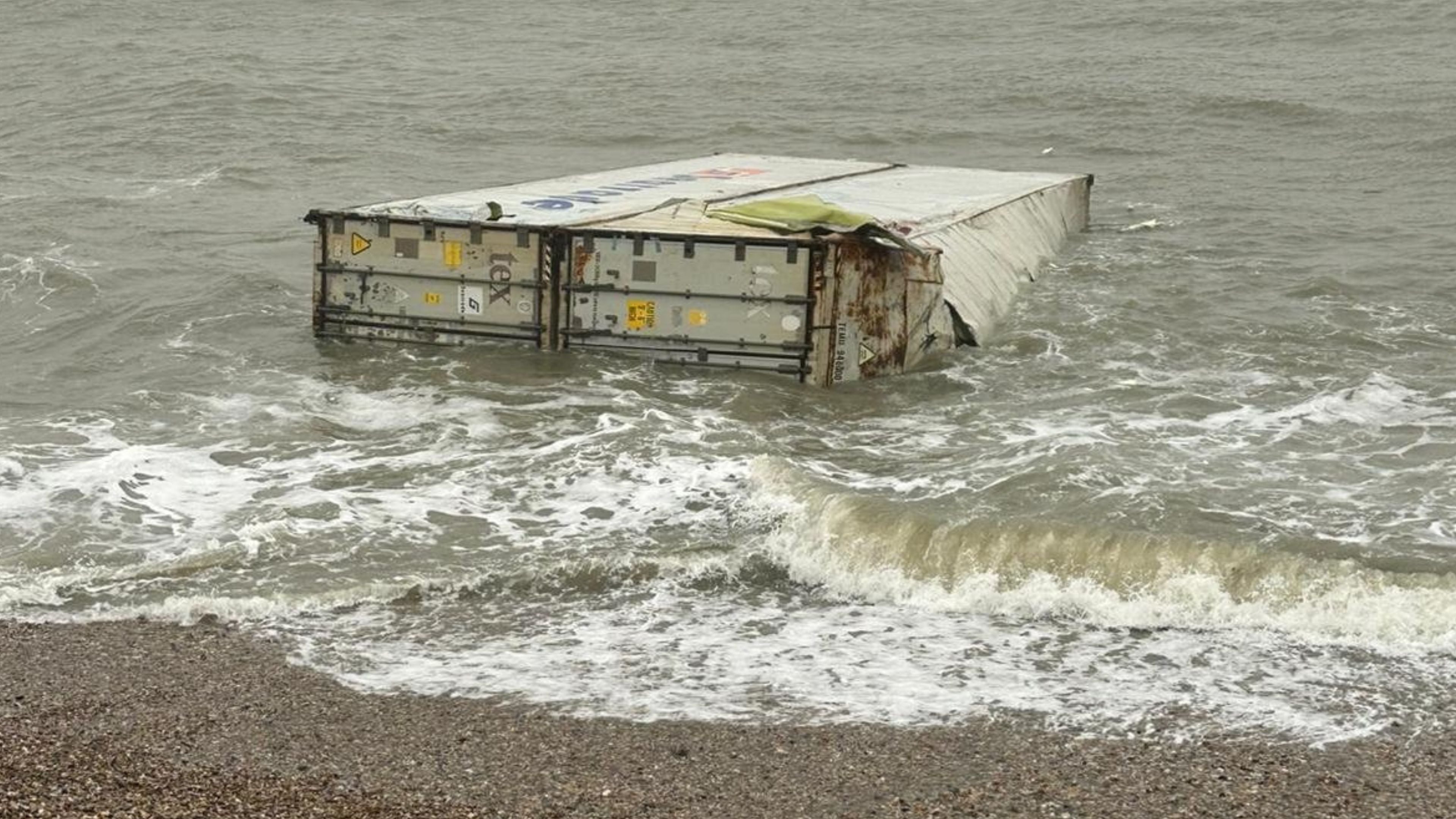 Bananas wash up on a beach as shipping containers topple overboard from ...