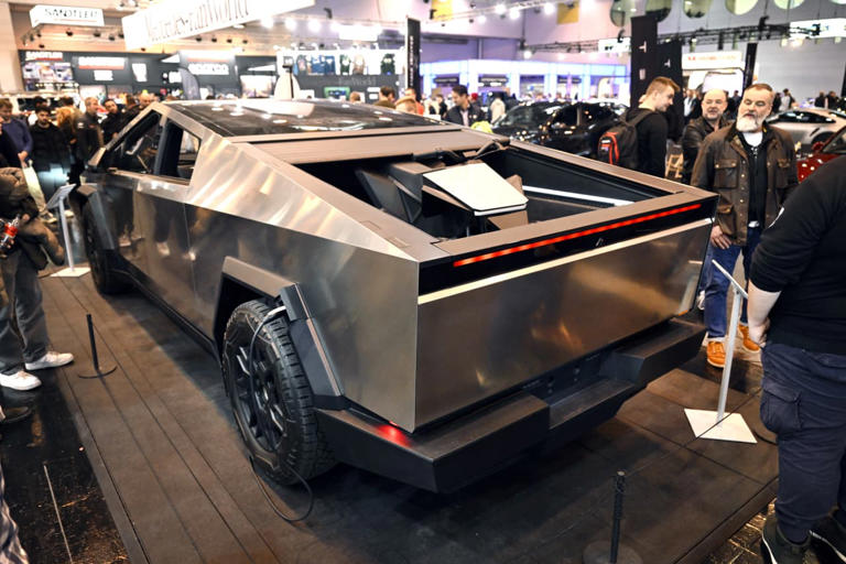 Tesla stock drops on a downgrade. Why its price target was raised.