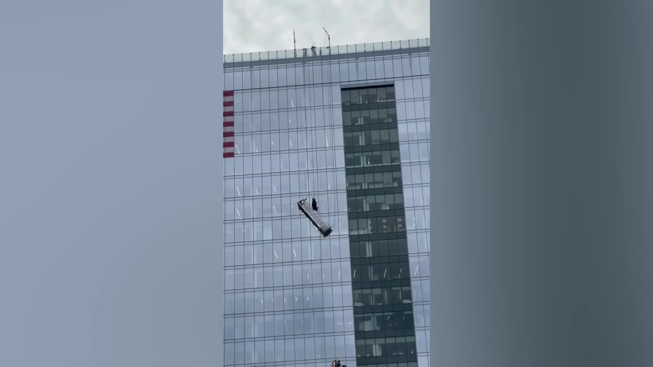 Firemen rescue high-rise window cleaners when basket jams on office tower