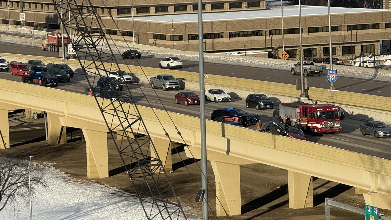 FBI agent rescued after car left resting on top of retaining wall on I ...