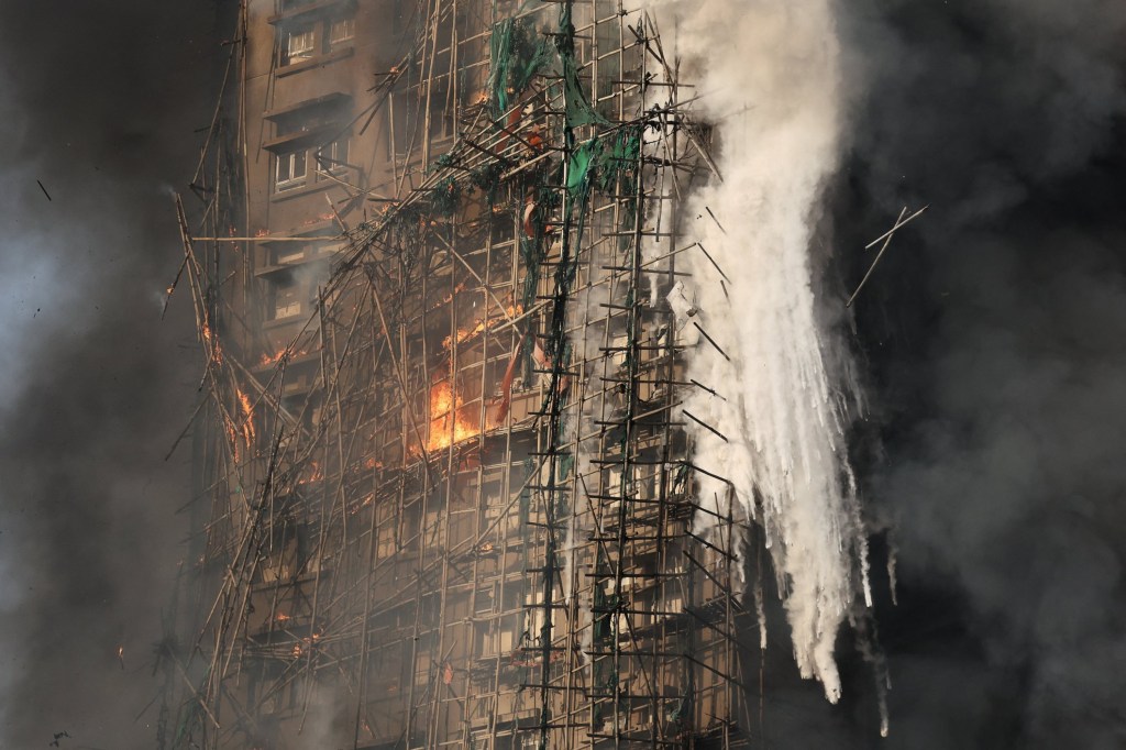 At least 13 dead after fire spreads on skyscrapers’ bamboo scaffolding