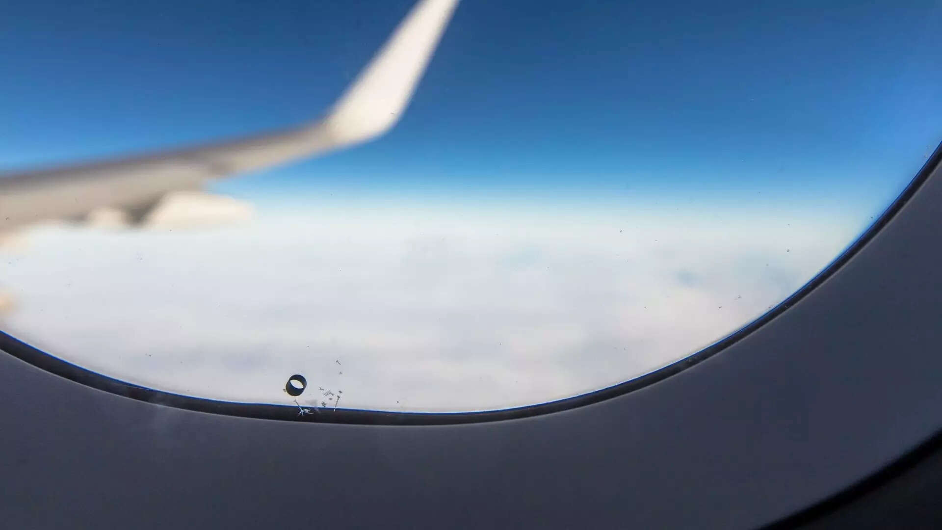 Why airplane windows have a tiny hole