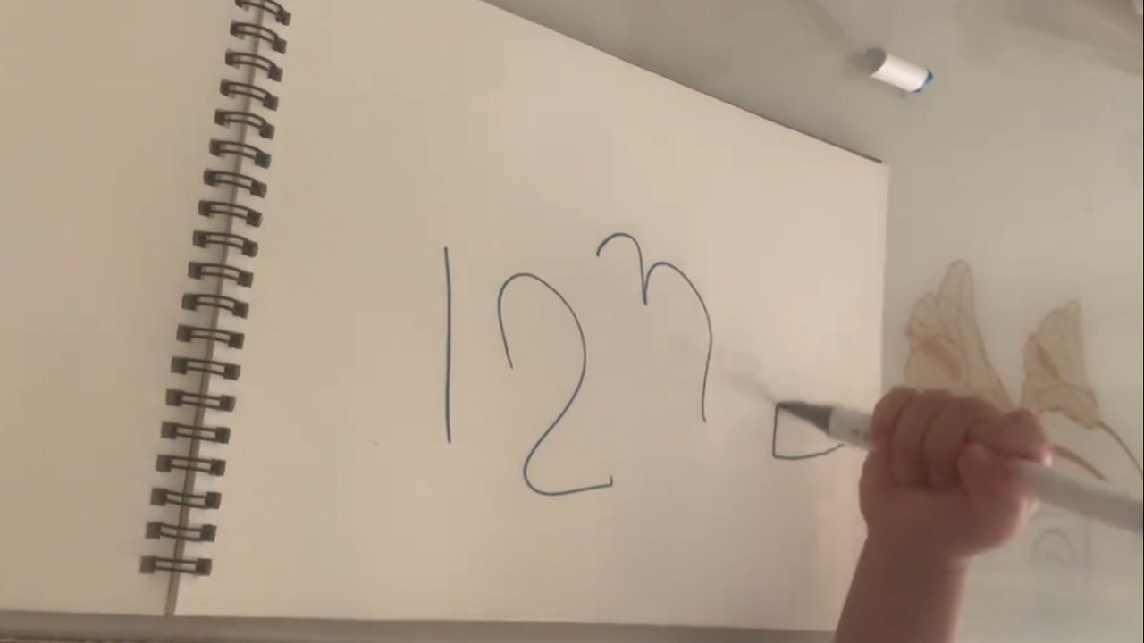 Child proudly shows writing numbers 1 to 10 in Shanxi, China