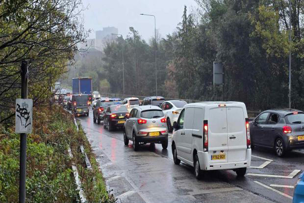 Main road closed following concern for welfare of woman on bridge