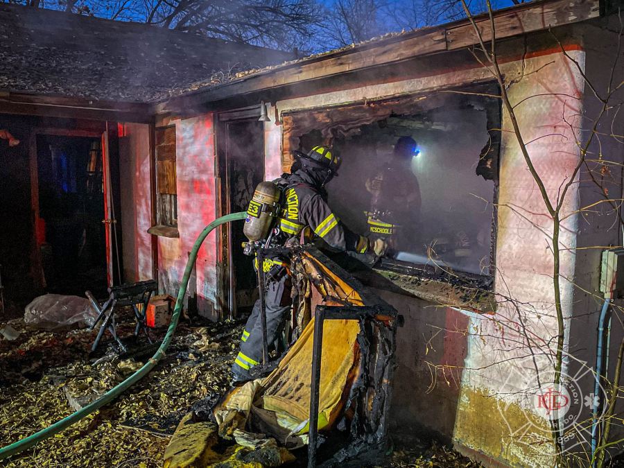 Unoccupied boarded up house catches fire