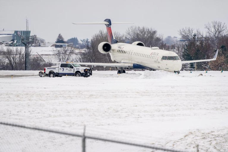 Delta plane skids off icy Iowa runway as winter chaos knocks out power ...