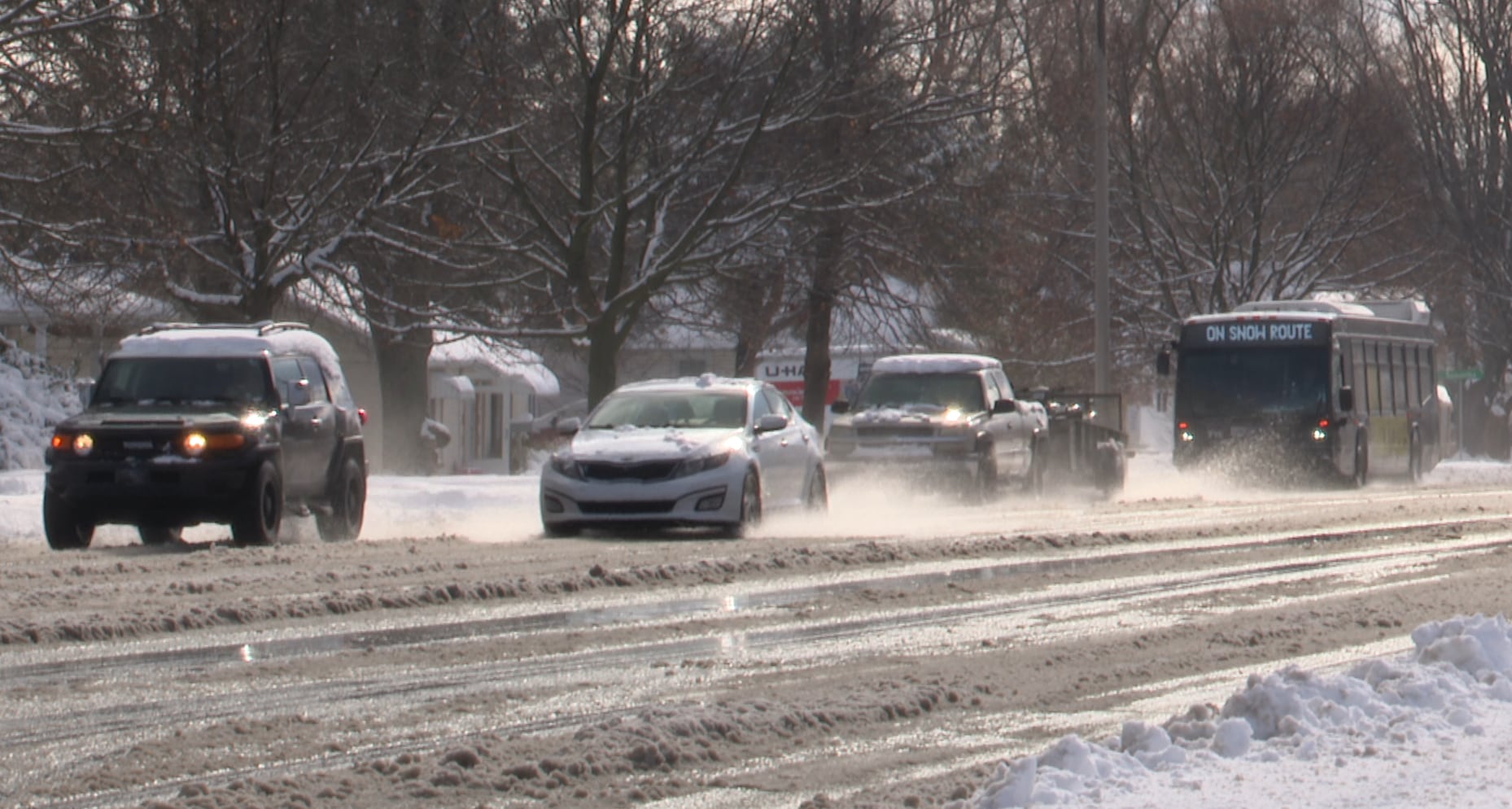 Holiday travelers take on busy and slick roads