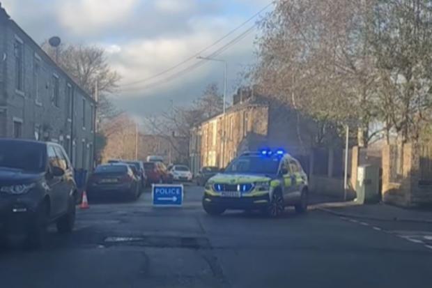 Police closed road and make arrest after van crashed into parked vehicles