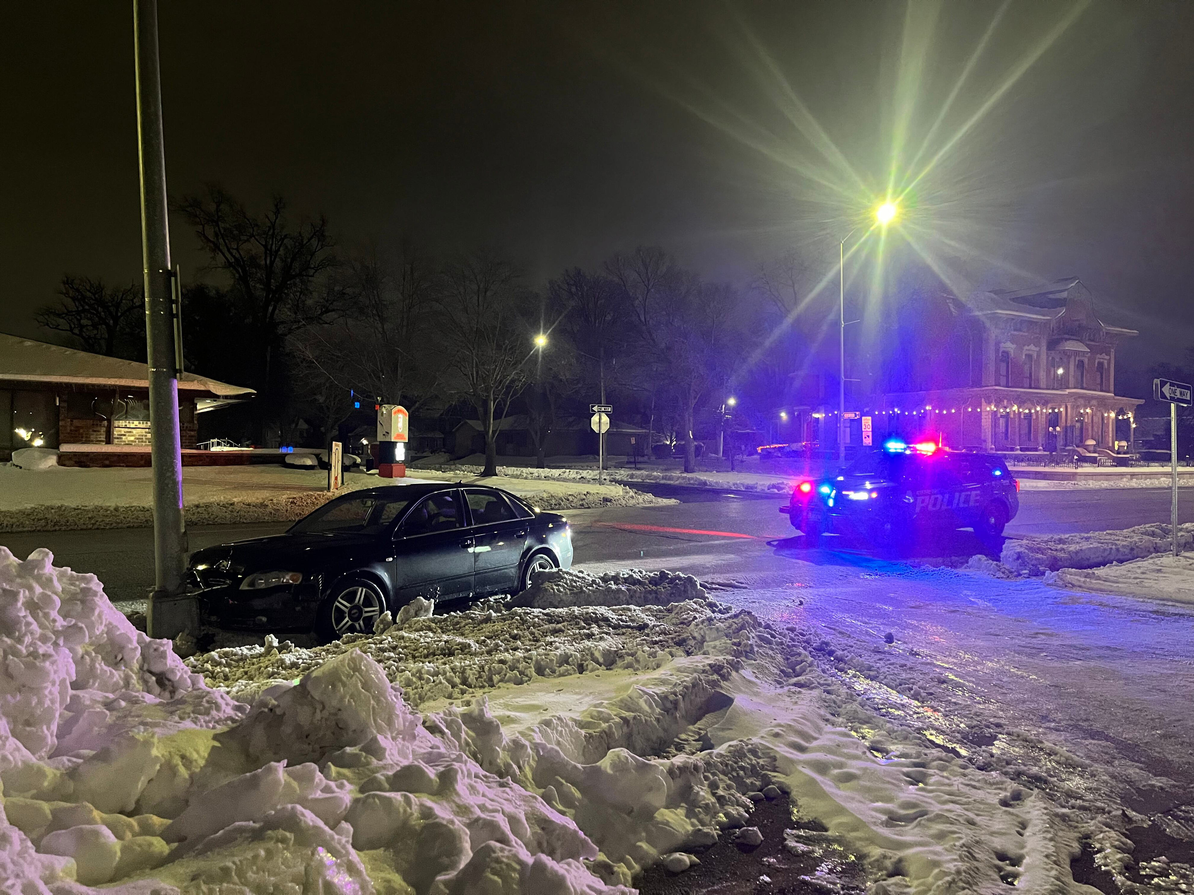 Car slides into pole due to icy roads, police say