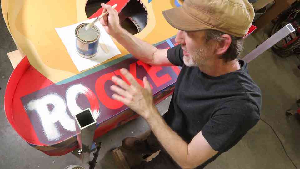 Handmaking a space age sign for a donut shop