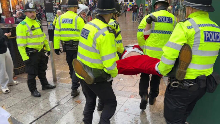 Police arrest ‘Santa’ and drag him through busy city centre