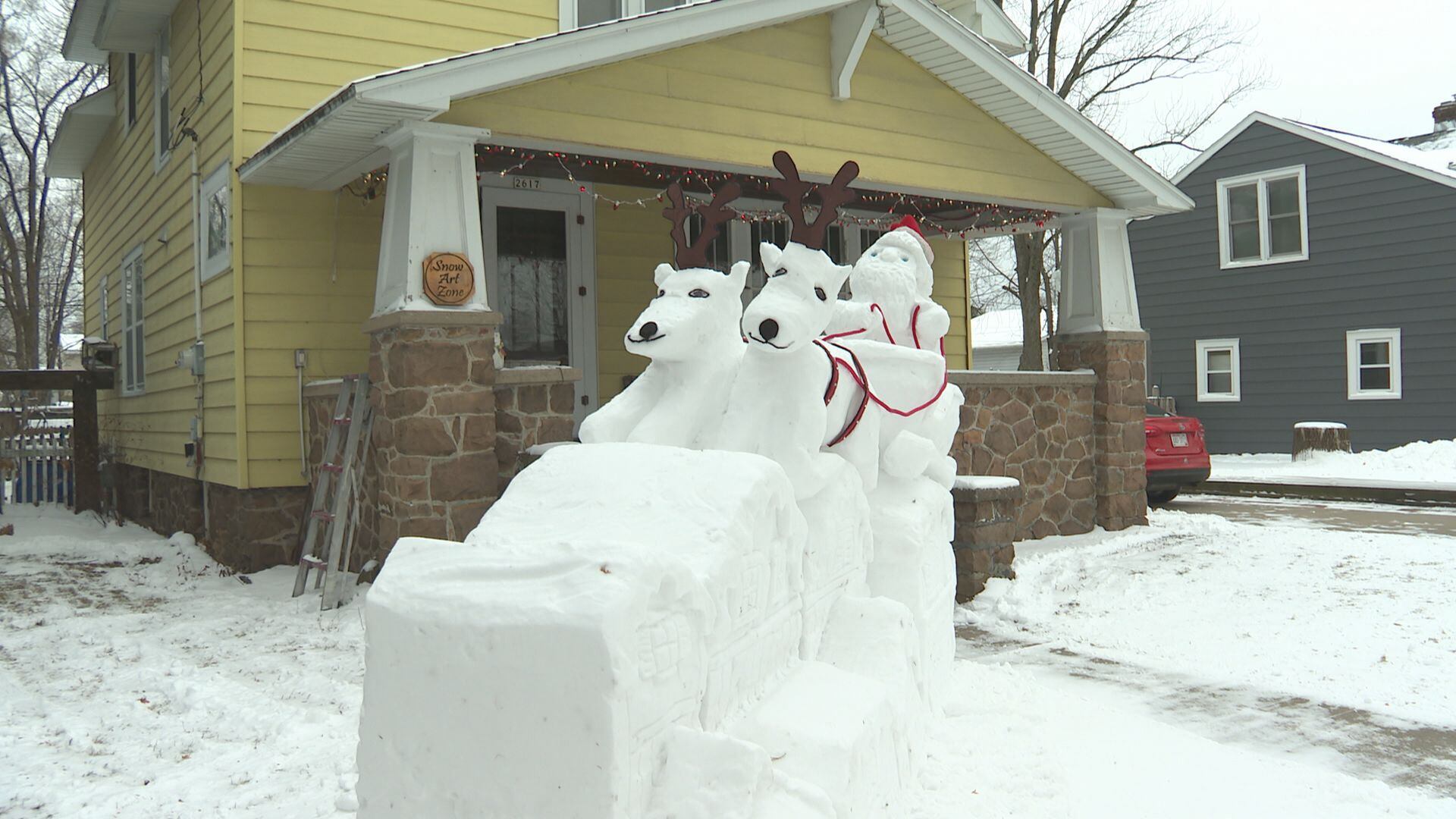 Snow sculptor makes largest design of season after first snowstorm