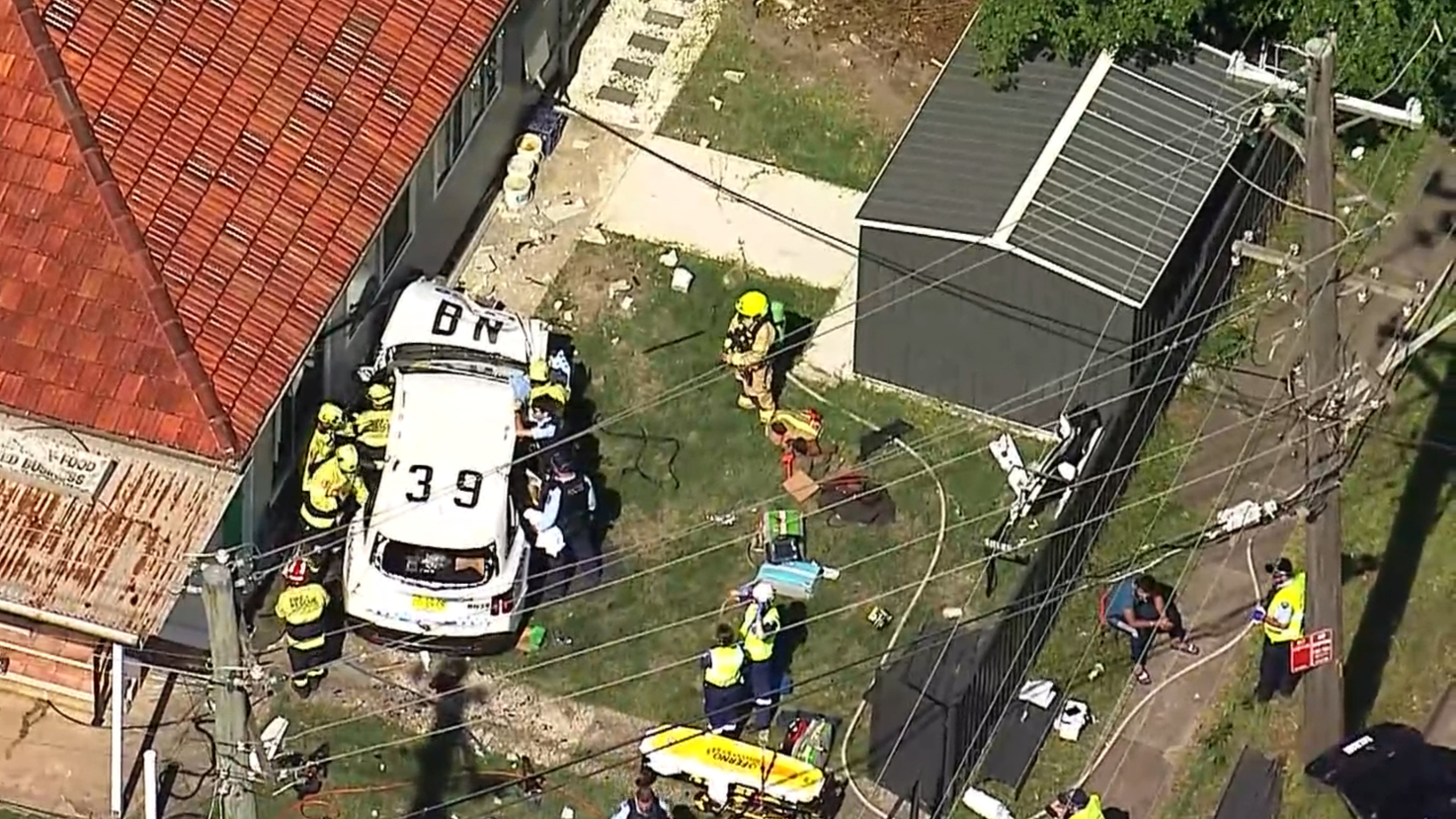 Police officer trapped in vehicle following two-car crash in Sydney's west