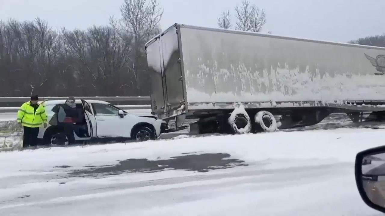 Cars and trucks stuck on snow-covered Interstate 70 as wintry weather ...