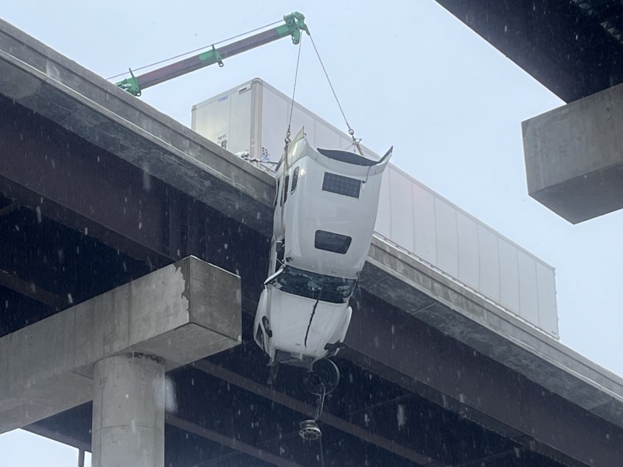 Driver rescued from tractor-trailer hanging over bridge on US 35 in ...